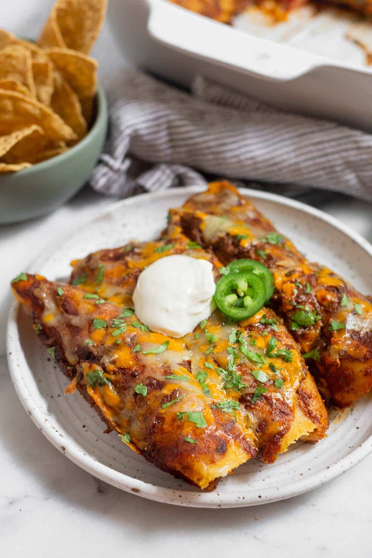 Healthy Chicken Enchiladas with Red Sauce - Eat the Gains